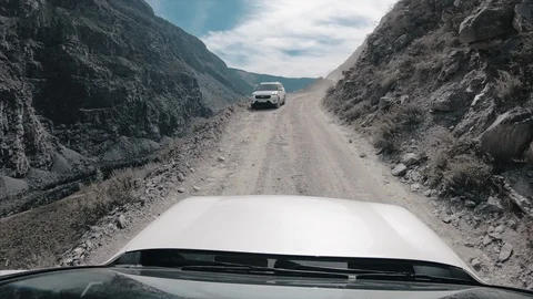 Car moves along the graver bumpy road | Stock Video | Pond5