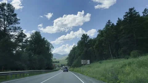 A car ride on the background of a mounta... | Stock Video | Pond5