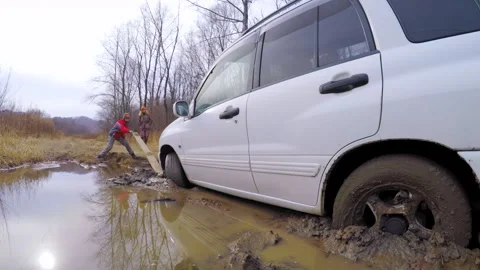 Car stuck in mud. View of spinning wheel... | Stock Video | Pond5