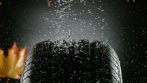 Car Tire with Water Splash and Autumn Le... | Stock Video | Pond5