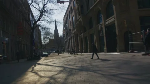Car Turning Corner As People Walk - Schl... | Stock Video | Pond5