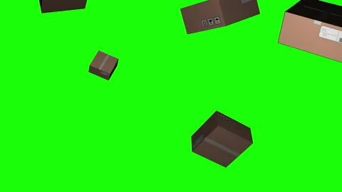 Cardboard box falling in front of green ... | Stock Video | Pond5