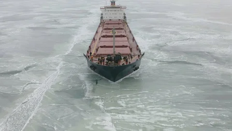 Cargo ship sailing on frozen sea in extr... | Stock Video | Pond5