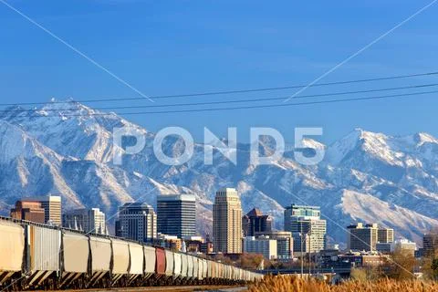 Cargo Train Journey: 4K View of Salt Lake City with Snow-Capped ...