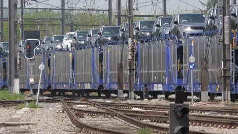 Cargo train with SUV cars at marshalling... | Stock Video | Pond5