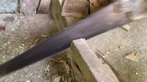 Carpenter cutting lumber with a hand saw... | Stock Video | Pond5