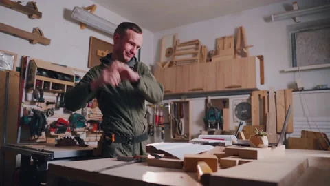 A carpenter is dancing in the workshop. ... | Stock Video | Pond5