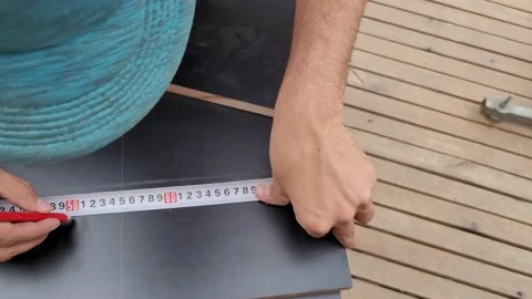 Carpenter measuring mdf boards with a ta... | Stock Video | Pond5