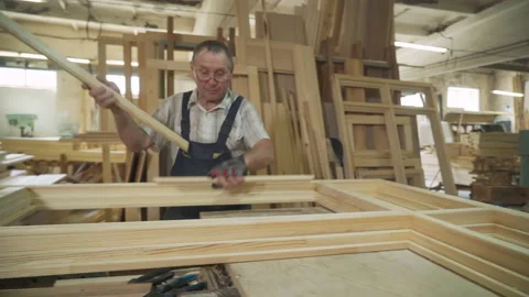 A carpenter is placing the multiple wind... | Stock Video | Pond5