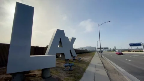 Cars driving by the LAX sign for Los Ang... | Stock Video | Pond5