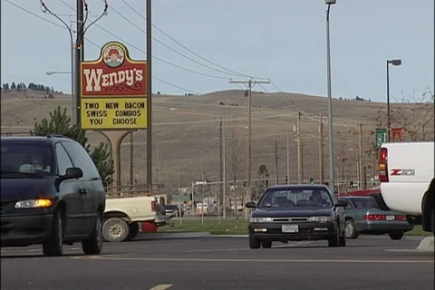 Cars Driving past Wendys Sign | Stock Video | Pond5