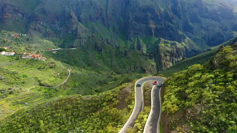 Cars driving through sharp turn on windi... | Stock Video | Pond5