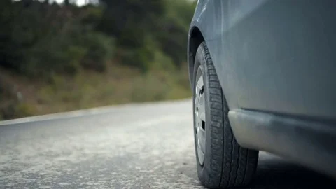 Car's left front tire close up video on ... | Stock Video | Pond5