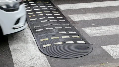 Cars on a speed bump before crosswalk. W... | Stock Video | Pond5