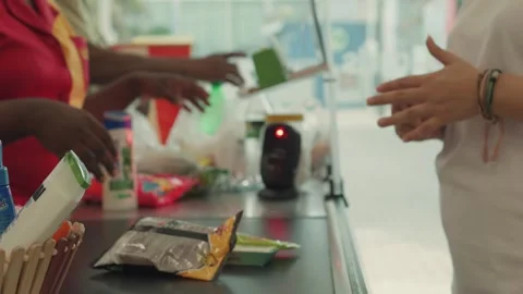 Cashier scanning goods on conveyor belt ... | Stock Video | Pond5