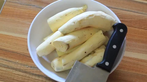 Cassava Root Fruit on a Table in removin... | Stock Video | Pond5