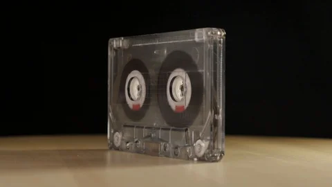 Cassette Tape rotating before black back... | Stock Video | Pond5