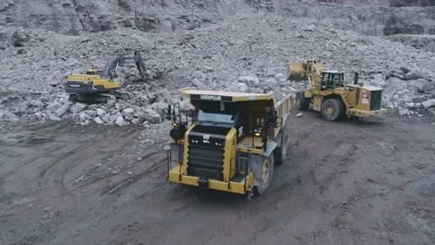 Caterpillar dump truck is being loaded a... | Stock Video | Pond5