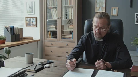 Catholic Pastor At Work In Office | Stock Video | Pond5
