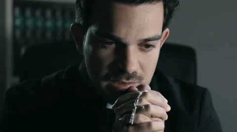 catholic priest is crying while praying ... | Stock Video | Pond5