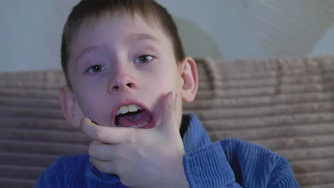 caucasian boy 9-10 years old looks at th... | Stock Video | Pond5