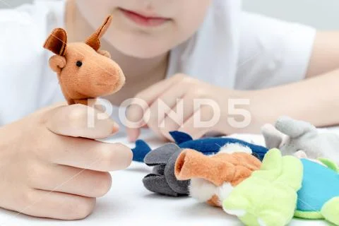 Photograph: A caucasian boy playing different roles by using finger ...