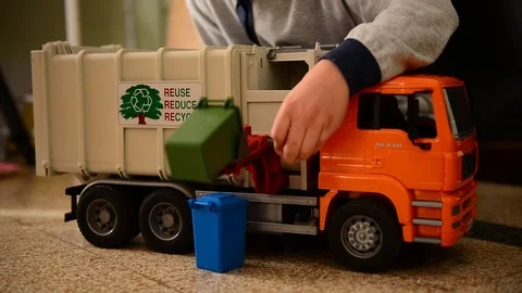 Caucasian child playing with garbage tru... | Stock Video | Pond5