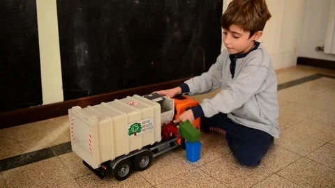 Caucasian child playing with garbage tru... | Stock Video | Pond5