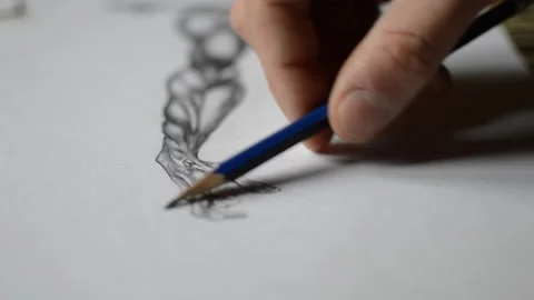 Caucasian man with pencil drawing on pap... | Stock Video | Pond5