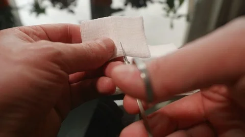 Caucasian man's hands cut medical gauze ... | Stock Video | Pond5