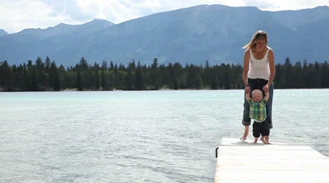 Caucasian mother helps baby boy walk up ... | Stock Video | Pond5
