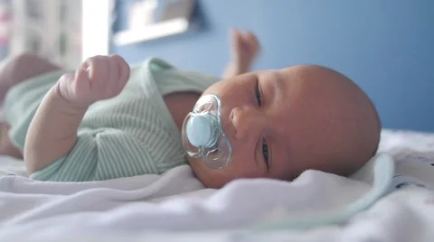 Caucasian newborn lying in a bed, lettin... | Stock Video | Pond5