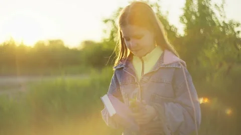 Caucasian teenage girl reading a book in... | Stock Video | Pond5