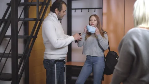 Caucasian woman see off husband and daug... | Stock Video | Pond5