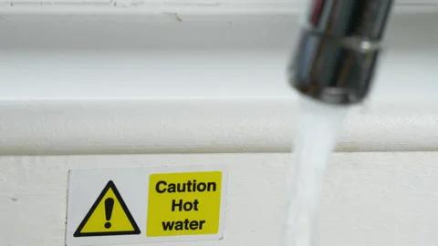 Caution Hot Water sticker label next to ... | Stock Video | Pond5