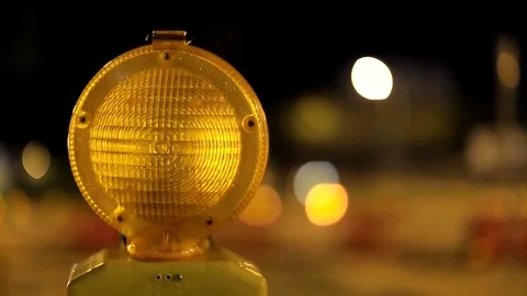 A caution sign is lit up by a blinking y... | Stock Video | Pond5