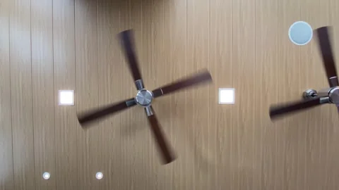 Ceiling fan spins quickly next to ceilin... | Stock Video | Pond5