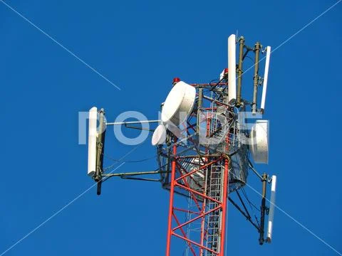 Cell antenna, transmitter. Telecom TV radio mobile tower against blue sky Stock Photo #77887800