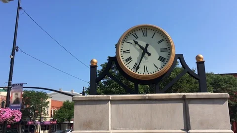 A centerpiece clock monument in a small ... | Stock Video | Pond5