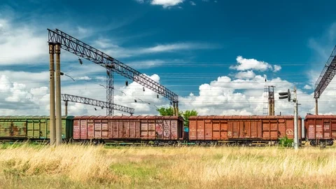 A chain of cargo wagons on a rail road a... | Stock Video | Pond5