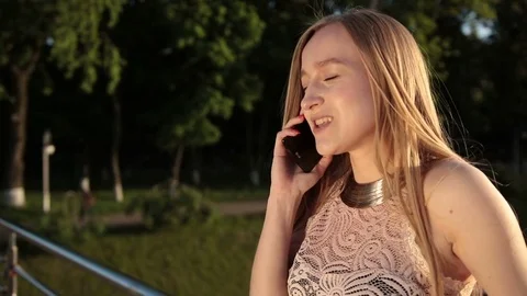 Charming girl talking on cellphone on th... | Stock Video | Pond5