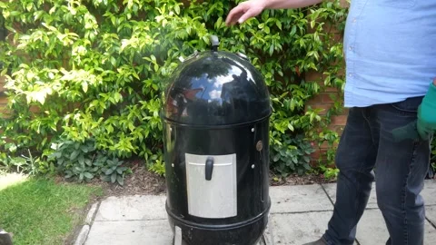 Checking bbq barrel smoker with brisket ... | Stock Video | Pond5