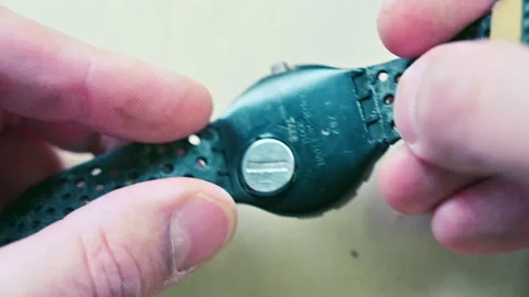 checking an old vintage model of swatch ... | Stock Video | Pond5