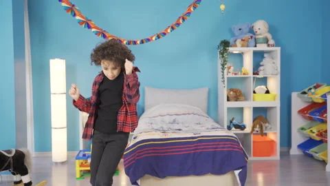 Cheerful and cute boy is dancing in his ... | Stock Video | Pond5