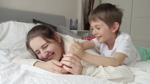 Cheerful laughing mother with son playin... | Stock Video | Pond5