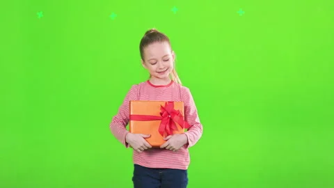 Cheerful little girl hugging gift box an... | Stock Video | Pond5