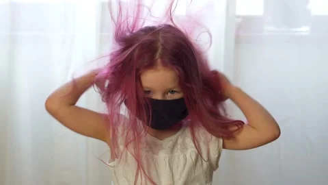 Cheerful little girl in a mask is dancin... | Stock Video | Pond5