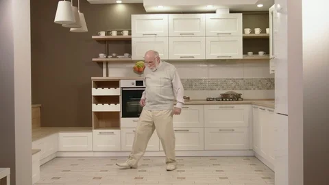 Cheerful Old Man Dancing In The Kitchen | Stock Video | Pond5