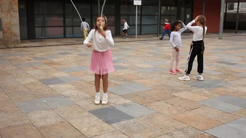 Cheerful sporty tween girl jumping rope ... | Stock Video | Pond5