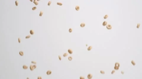 Cheerios cereal raining down on white ba... | Stock Video | Pond5